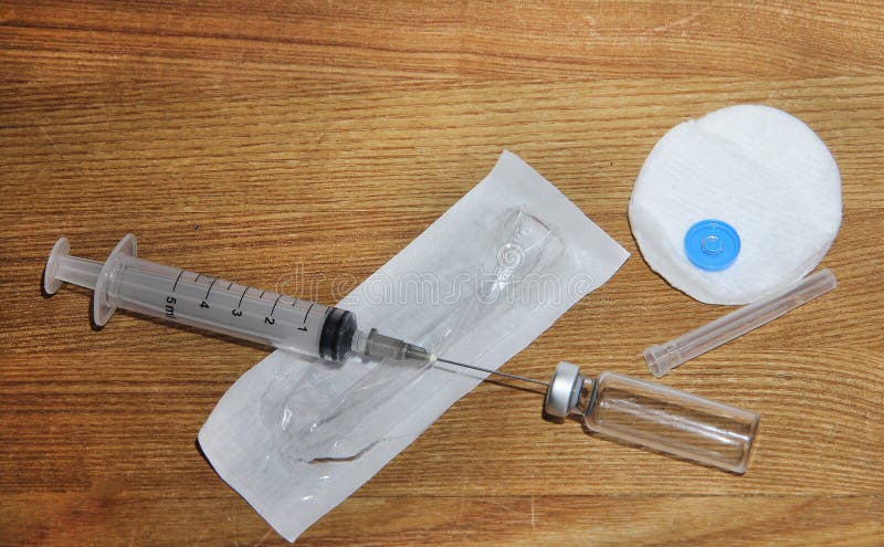 On the Wooden Surface is a Syringe, Ampoule, Sponge. Stock Image ...
