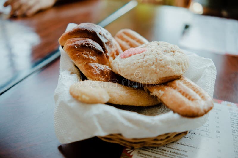 Wooden Table with a Basket Full of Assorted Bread, Ready for Serving ...