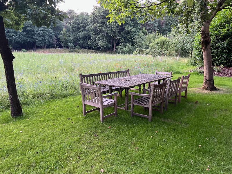 Wooden Table with Bench and Chairs in Garden. Landscape Design Stock ...