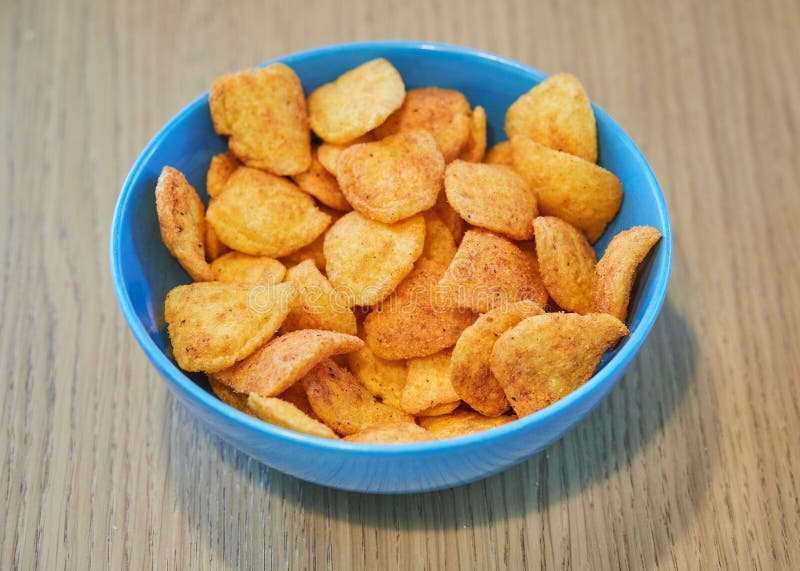 Wooden Table with a Blue Bowl Full of Potato Chips Stock Image - Image ...