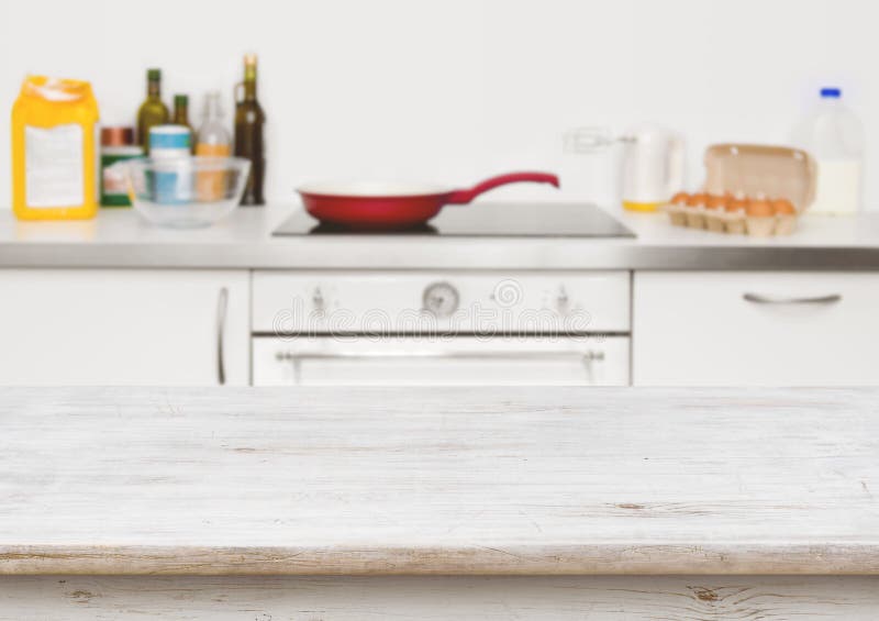 Wooden Table in Focus Over Blurred Baking Ingredients on Kitchen Stock ...