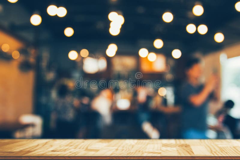 Wooden Table in Front of Abstract Blurred Coffee Shop Lights Background ...