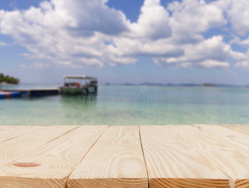 Wooden Table in Front of Abstract Blurred in View of the Sea Background ...