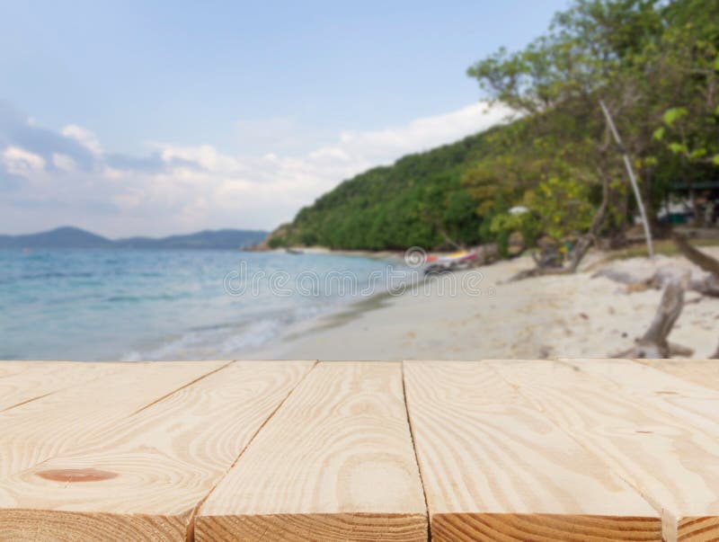 Wooden Table in Front of Abstract Blurred in View of the Sea Background ...