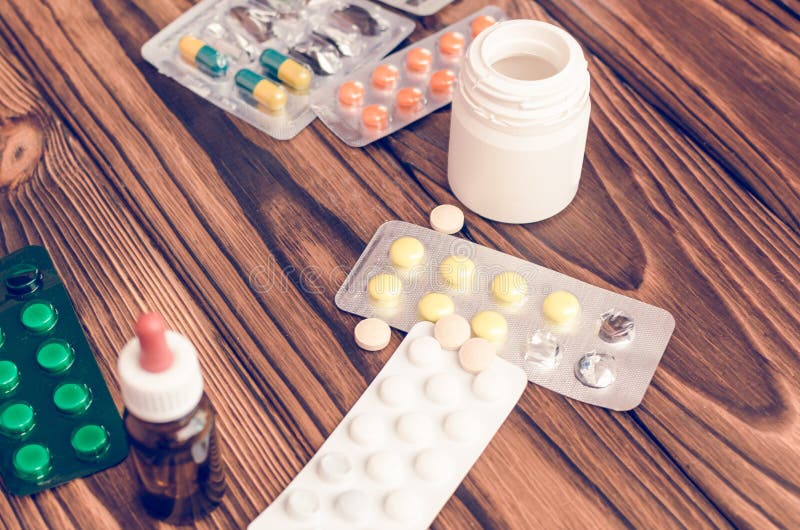 On a Wooden Table Lie Tablets and Drops Stock Image - Image of ...