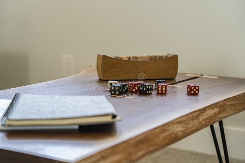 A Wooden Table with a Notebook and a Pile of Dice on it Stock Image ...