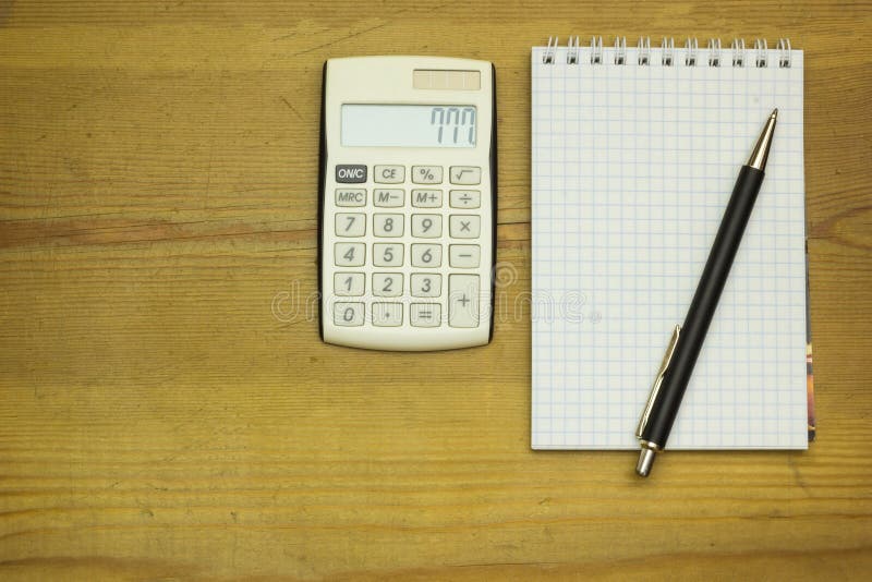 Wooden Table at Office with Calculator, Pen and Paper. Background with ...