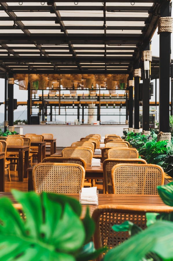 Wooden Table and Rattan Chairs at Open Cafe Outdoor. Stock Photo ...