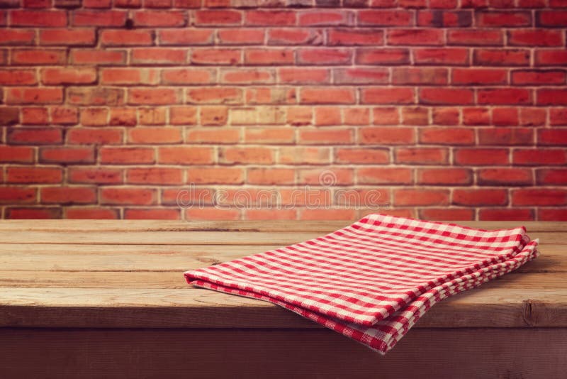 Wooden Table with Red Checked Tablecloth Over Brick Wall Stock Photo ...