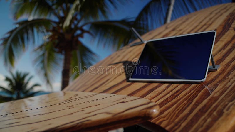 Wooden Table with Tablet Computer Displaying Blue Screen, Situated on ...