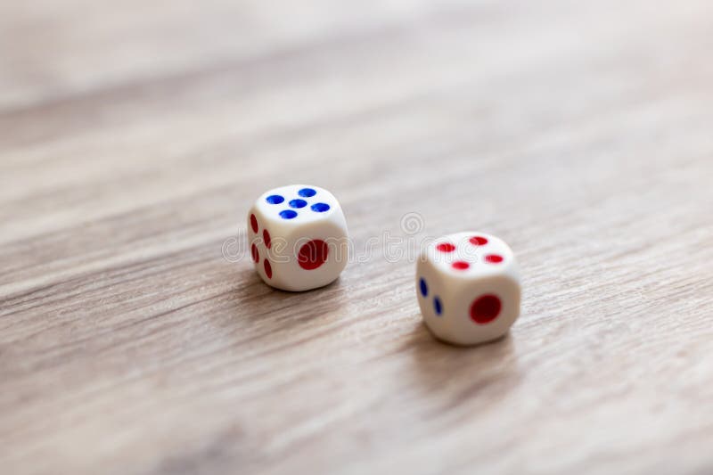 On a Wooden Table, There are Two Dice Featuring Red and Blue Dots Stock ...