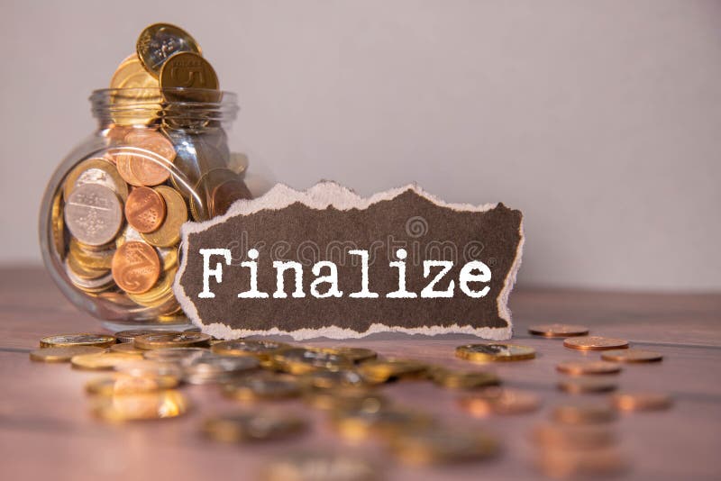 On a Wooden Table are Two Wooden Blocks with the Text FINALIZE Stock ...