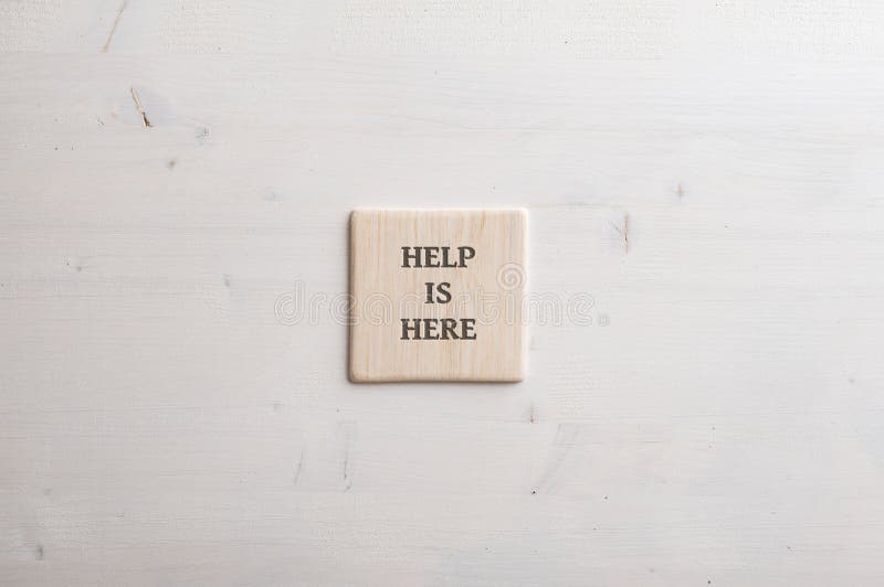 Wooden Tile with a Help is Here Sign Written on it Stock Photo - Image ...