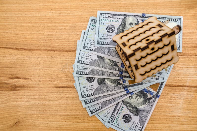 Wooden, Toy House and Dollars on a Wooden Background. Stock Image ...