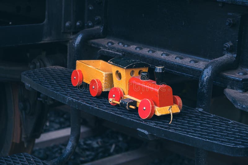Small Wooden Toy Train on Steps of an Historic Big Train Stock Photo ...