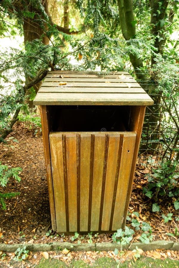 Wooden Trash Bin in Forest Setting Surrounded by Green Foliage and ...
