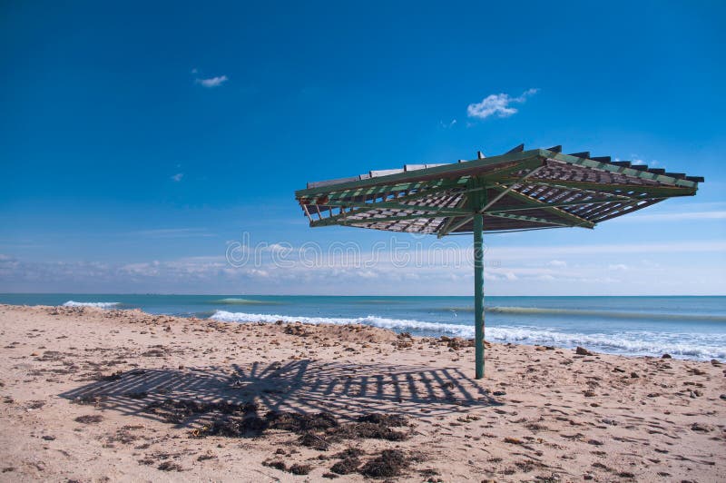 Wooden Umbrella on Empty Beach Stock Photo - Image of flood, empty ...