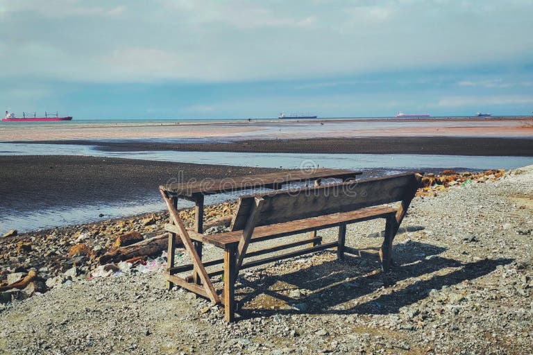 Wooden Viewing Bench on a Receding Beach Stock Image - Image of coast ...