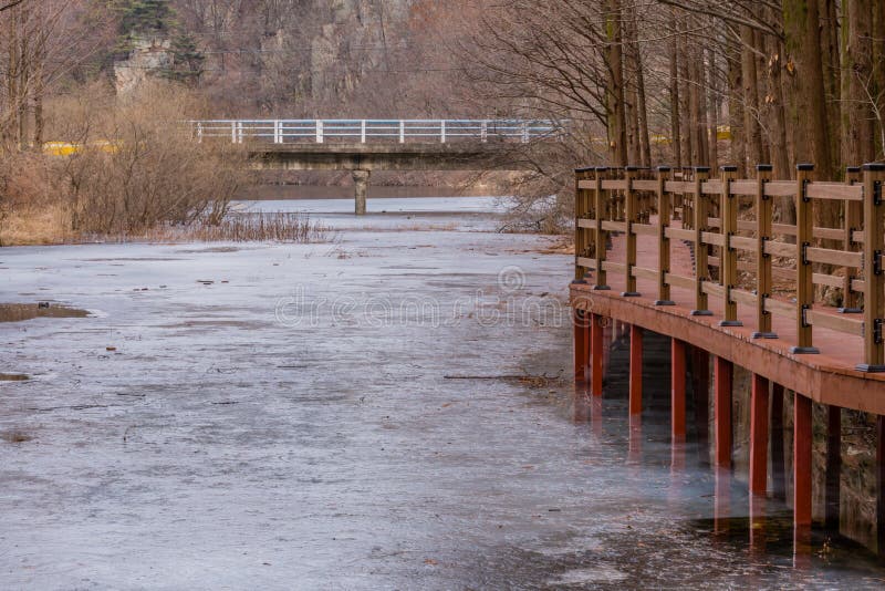 Wooden Walkway Alongside Frozen River Stock Photo - Image of fall ...