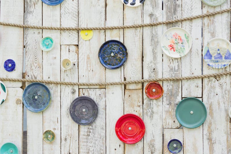 Wooden Wall Decorated Ceramic Plates. Bright and Colorful Background in ...