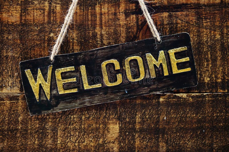 Wooden Welcome Sign Hanging on Space Wooden Background Stock Photo ...