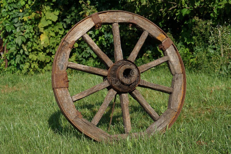 Wooden Wheel on a Background of Green Grass Stock Image - Image of ...