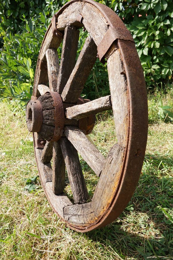 Wooden Wheel on a Background of Green Grass Stock Photo - Image of barn ...