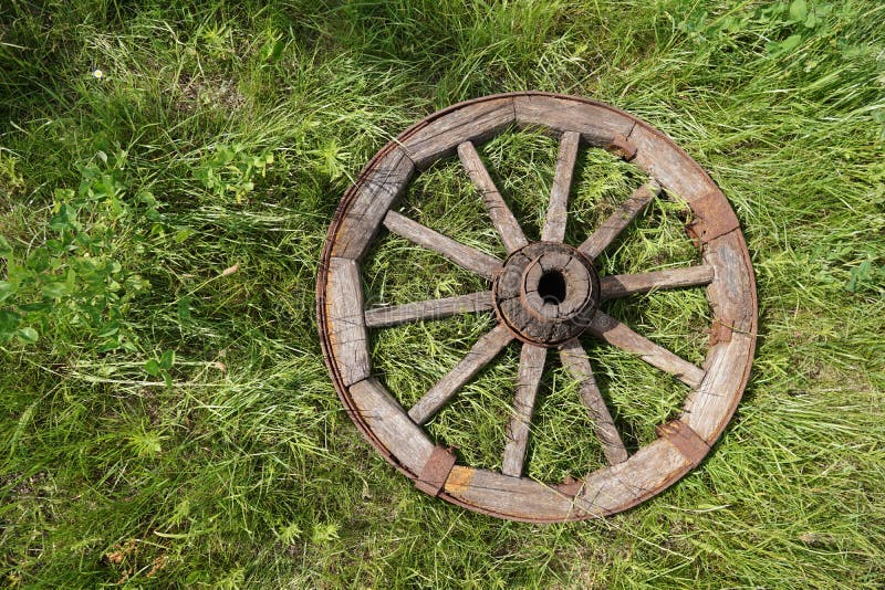 Wooden Wheel on a Background of Green Grass Stock Image - Image of ...