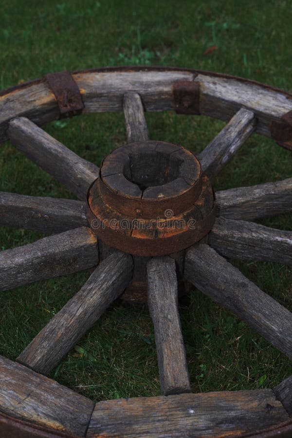 Wooden Wheel on a Background of Green Grass Stock Image - Image of ...
