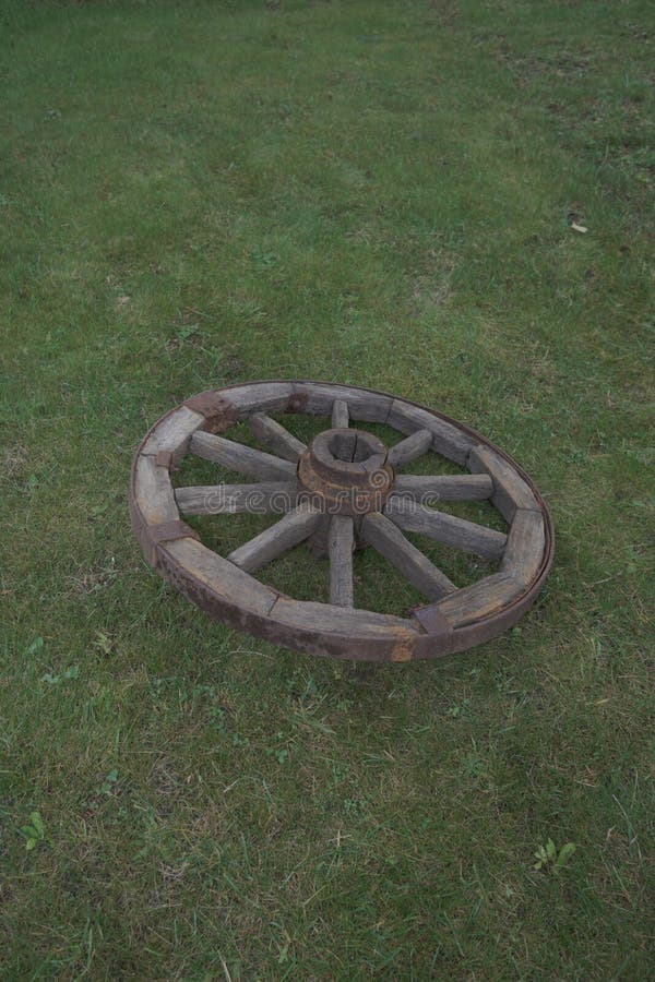 Wooden Wheel on a Background of Green Grass Stock Image - Image of cart ...