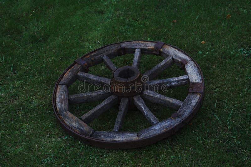 Wooden Wheel on a Background of Green Grass Stock Photo - Image of ...