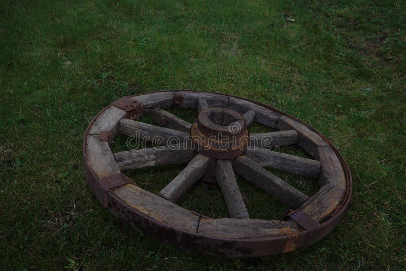 Wooden Wheel on a Background of Green Grass Stock Image - Image of ...