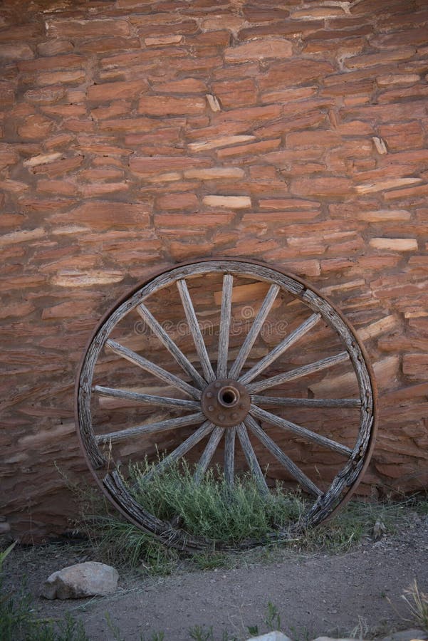 Wooden Wheel on Brick Wall Vertical Stock Photo - Image of western ...