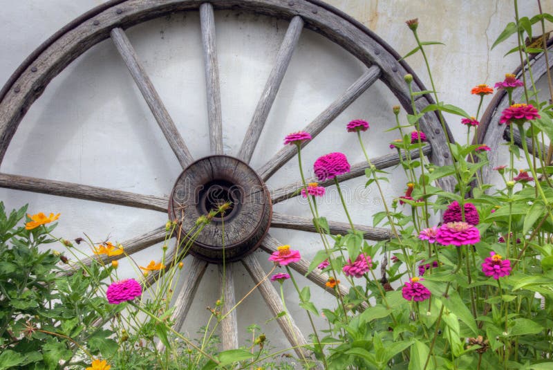Wooden Wheel and Flowers stock image. Image of spoke - 26650555
