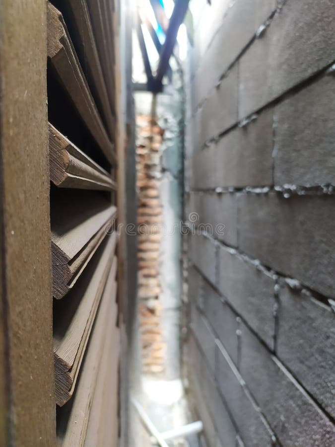 Wooden Window on the Left Side and Stone Walls on the Right Side with a ...