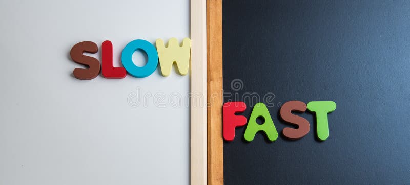Wooden Word SLOW and FAST on Black Board and White Board Stock Photo ...