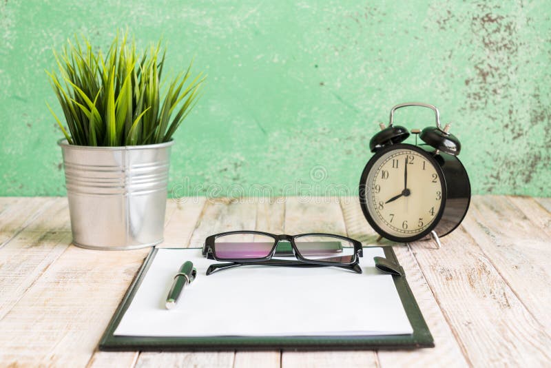 Wooden Workplace Desktop with Clock; Plants; Glasses; Frame and Stock ...