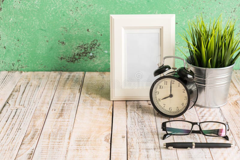 Wooden Workplace Desktop with Clock; Plants; Glasses; Frame and Stock ...
