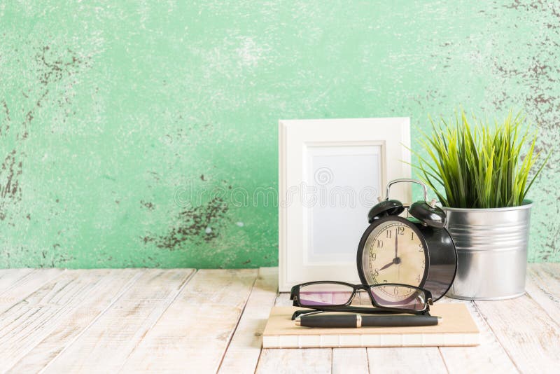 Wooden Workplace Desktop with Clock; Plants; Glasses; Frame and Stock ...