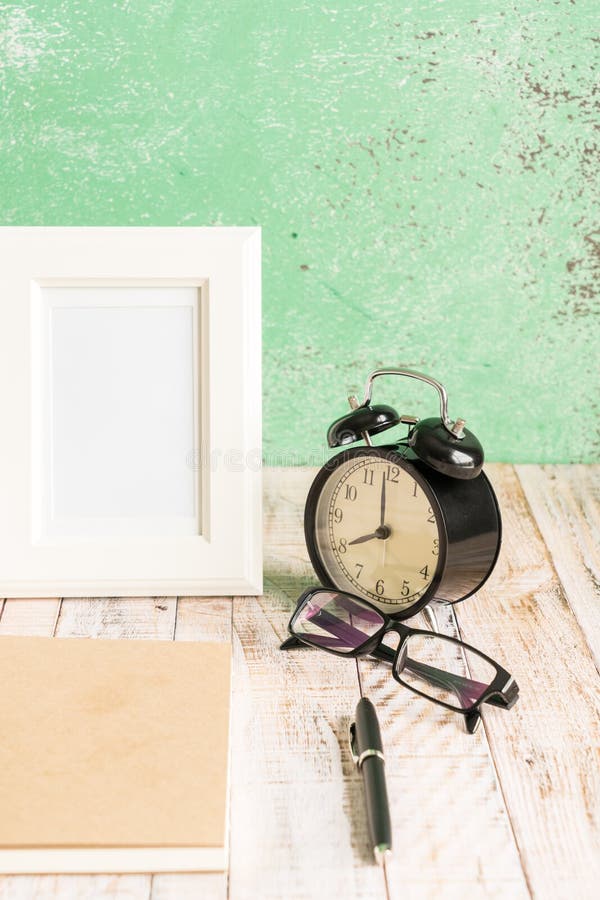 Wooden Workplace Desktop with Clock; Plants; Glasses; Frame and Stock ...