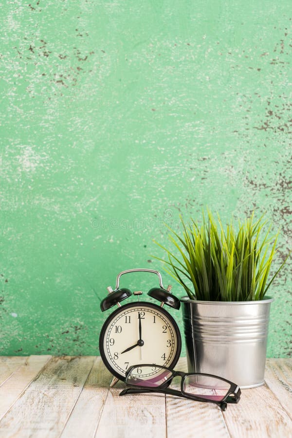Wooden Workplace Desktop with Clock; Plants; Glasses; Frame and Stock ...