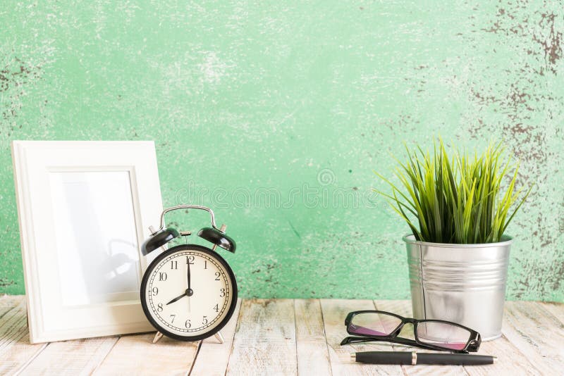 Wooden Workplace Desktop with Clock; Plants; Glasses; Frame and Stock ...