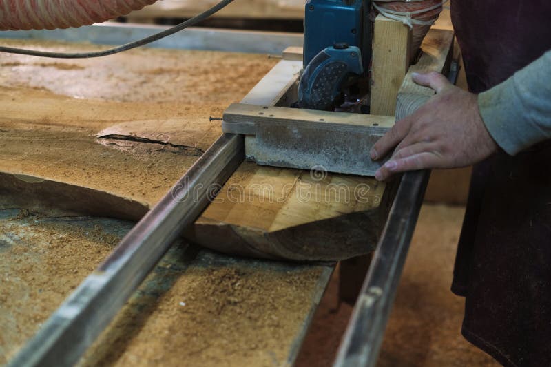The Woodworker Carefully Cuts through the Timber, Shaping a Future ...