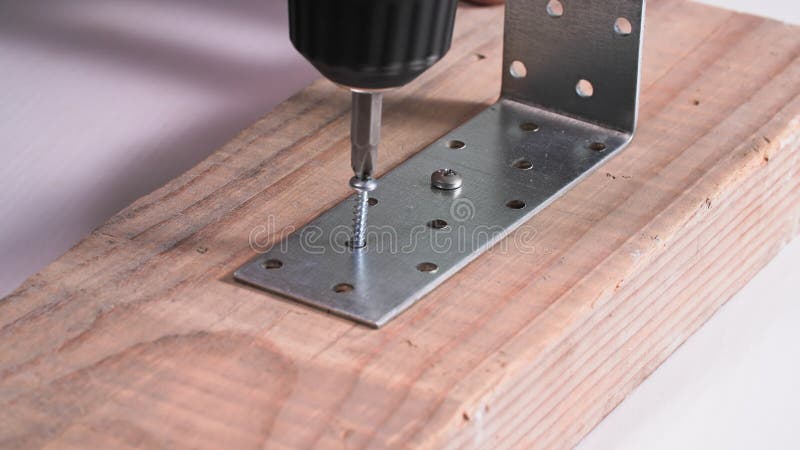 Woodworker, Man Using Working Tools Fastens a Metal Corner To Log ...