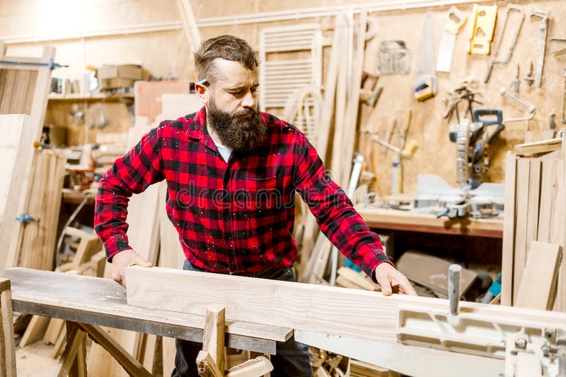 Woodworker Shaping a Plank in a Workshop with Tools and Equipment ...
