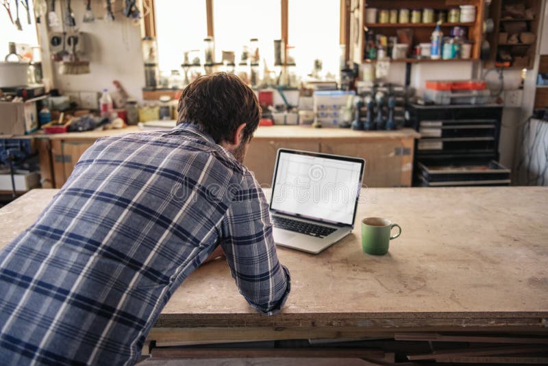 Woodworker Working Online with a Laptop in His Workshop Stock Image ...