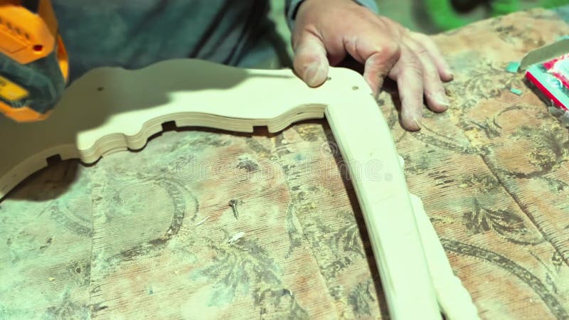 A Woodworking Carpenter Saws Off a Board with a Hand Saw. the Process ...