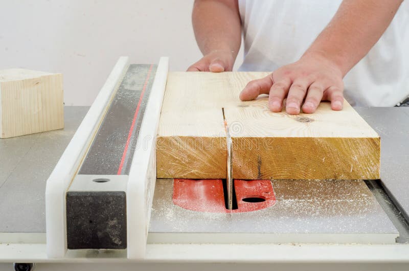 Woodworking, a Man Cutting a Board on a Circular Saw Machine Stock ...