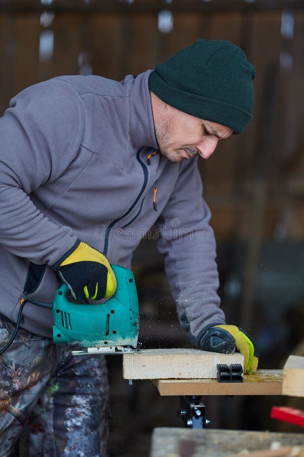 Woodworker using jigsaw stock photo. Image of board - 135613298