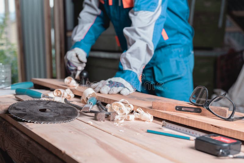 Woodworking Tools on the Table on the Background of Men at Work in Blur ...
